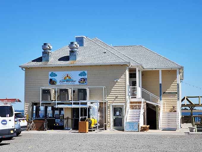 Weathered coastal siding and twin chimneys mark this waterfront gem where gravel parking leads to spectacular bay views.