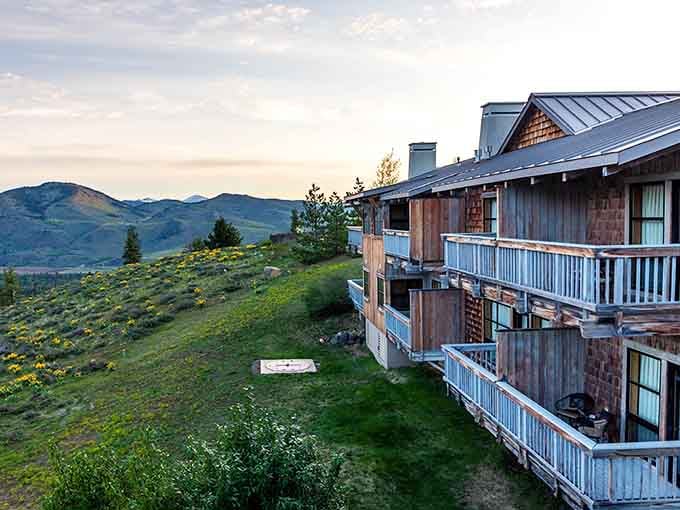 Wildflower-dotted hillsides surround these rustic balconies at golden hour&mdash;where sunrise coffee tastes better at mountain elevation.