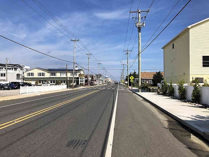 Clean island streets stretch toward the horizon, where beach houses line up like sentinels guarding coastal tranquility.