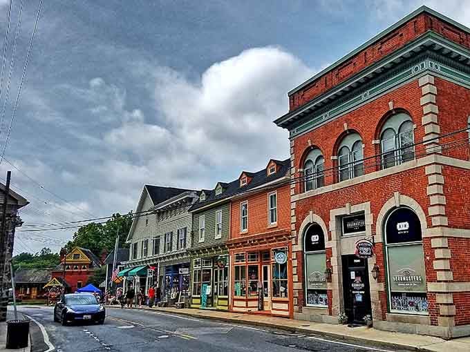 Sykesville's historic storefronts wear their age proudly, brick facades glowing warmly under dramatic clouds gathering overhead.