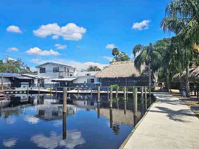 That thatched tiki hut and mirror-calm water create a postcard moment that'll make your neighbors jealous.