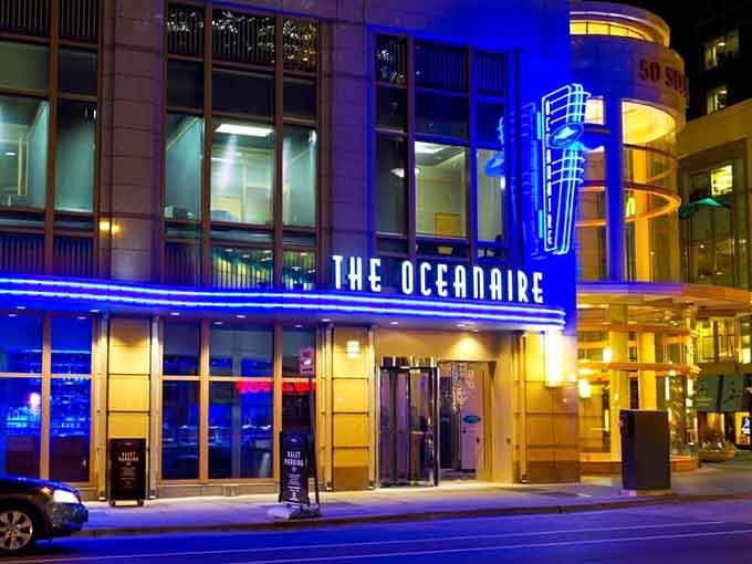 Electric blue neon transforms this downtown corner into a glamorous 1930s ocean liner docked right on Minneapolis streets.