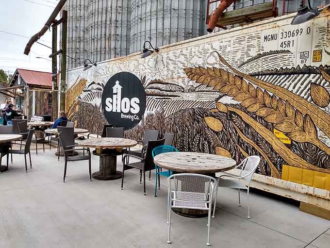 That stunning wheat mural transforms ordinary outdoor seating into an artistic experience where craft beer meets creative culinary vision beautifully.