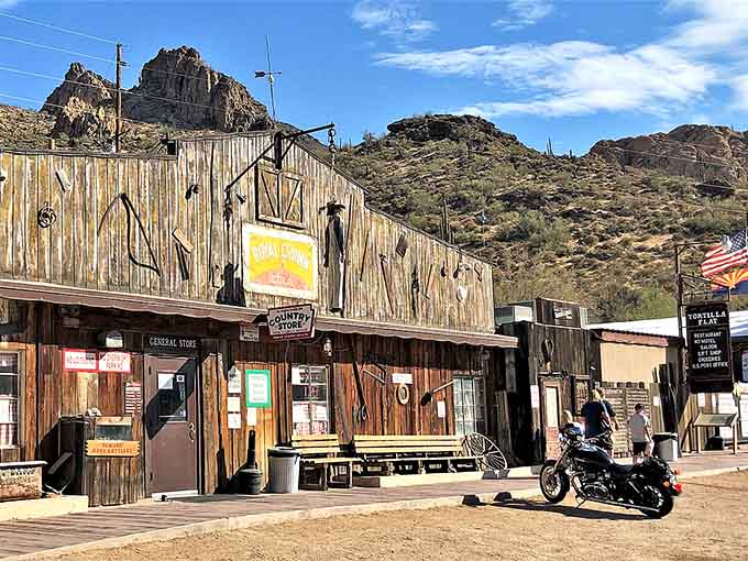 Weathered planks and rocky peaks frame this rustic outpost where civilization meets wild desert landscape head-on.