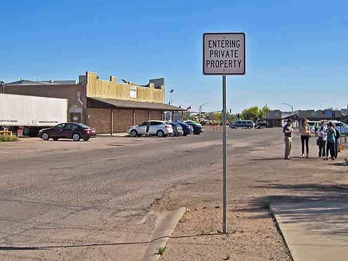 The "Entering Private Property" sign marks the gateway to community living, where neighbors become friends under Arizona's endless blue.