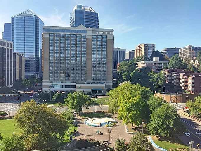 Glass towers reflect blue skies while green parks below offer perfect picnic spots after exploring the diverse restaurant scene nearby.