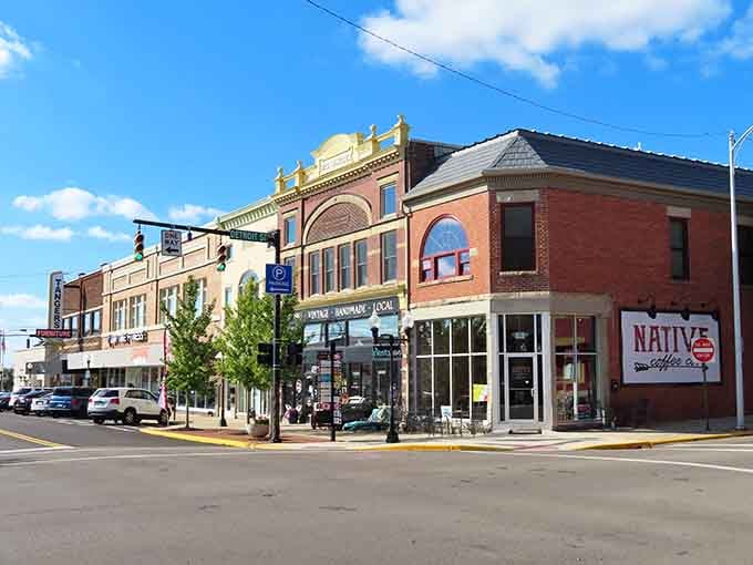 The storefronts give the street its steady rhythm, reflecting the pride and character of the community.