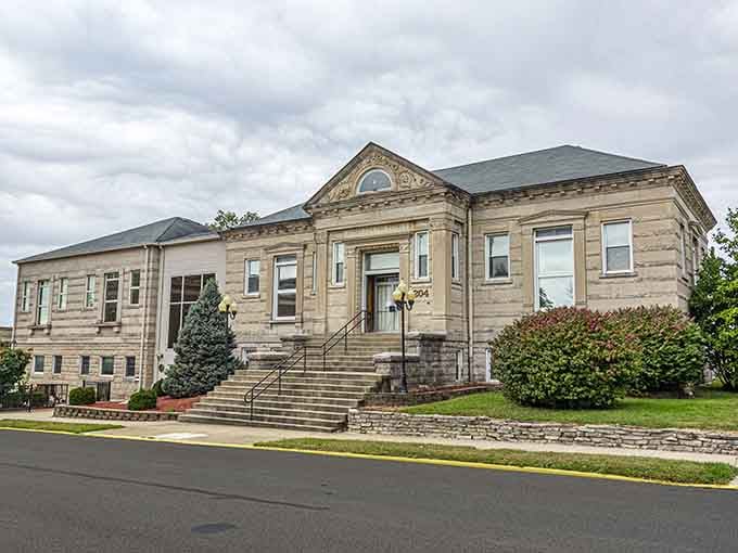 The weathered stone facade tells decades of stories while evergreens stand guard like patient sentinels of history.