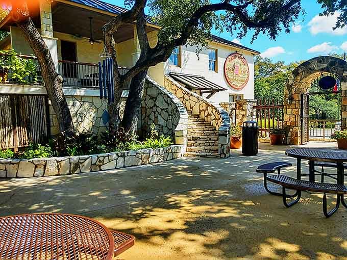 Dappled shade from towering oaks creates the perfect outdoor dining room where time slows down and conversations linger longer.