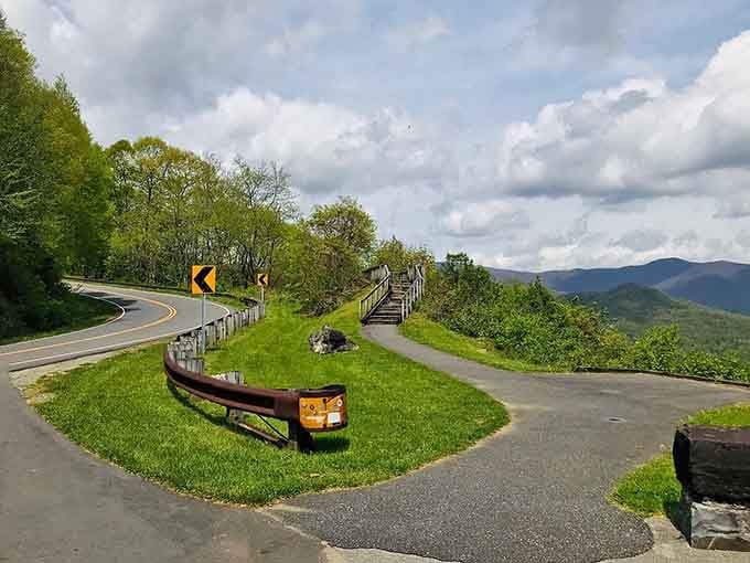 Dramatic clouds frame distant peaks while that perfect curve whispers promises of adventure just around the bend.