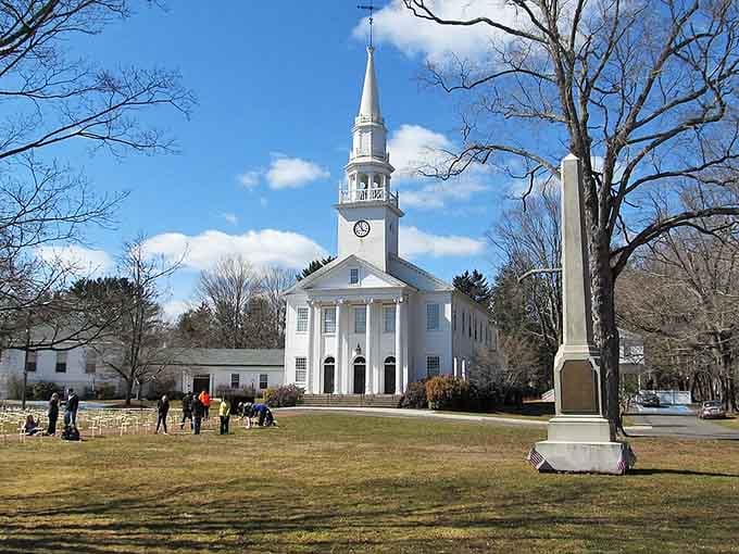 A pristine white church with soaring steeple stands as the heart of community life, just like Norman Rockwell would paint it.