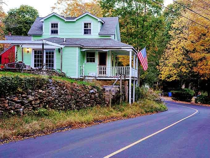 That mint-green house perched on the hillside brings more personality than most people manage in their entire wardrobes.