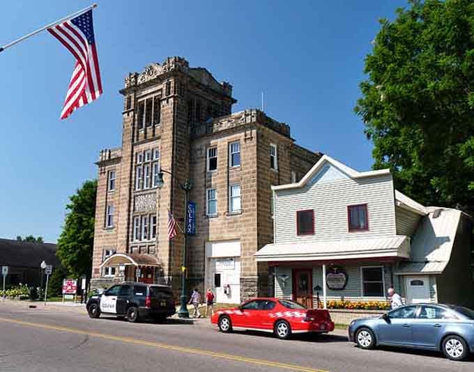 That historic tower building stands like a sentinel watching over a town that remembers when neighbors actually talked to each other.