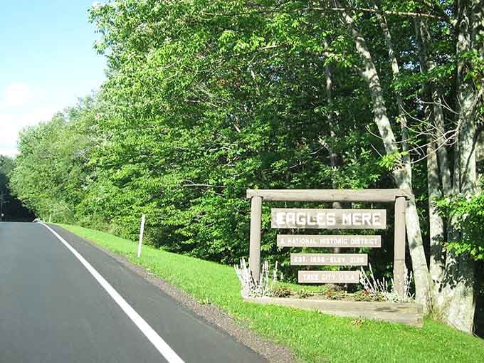 That rustic wooden sign welcomes travelers to a mountaintop retreat where time moves at its own pace.
