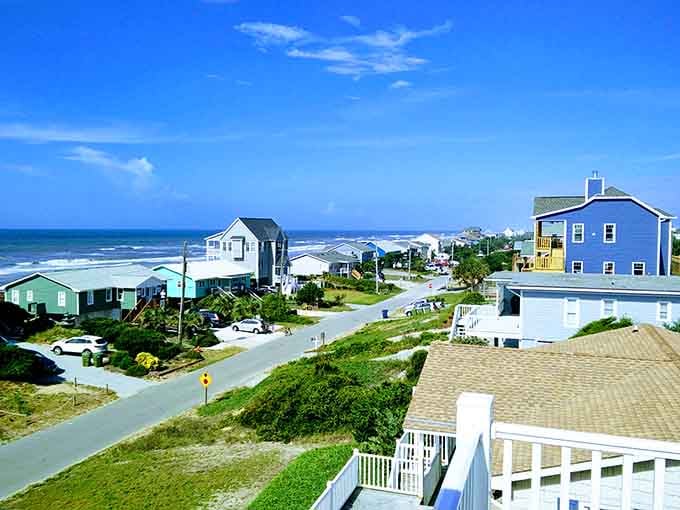 Beach houses in candy colors line up like a cheerful welcoming committee for ocean-loving visitors.