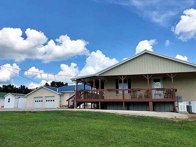 Blue skies and puffy clouds frame a simple community building where neighbors gather, proving the best architecture serves people, not egos.