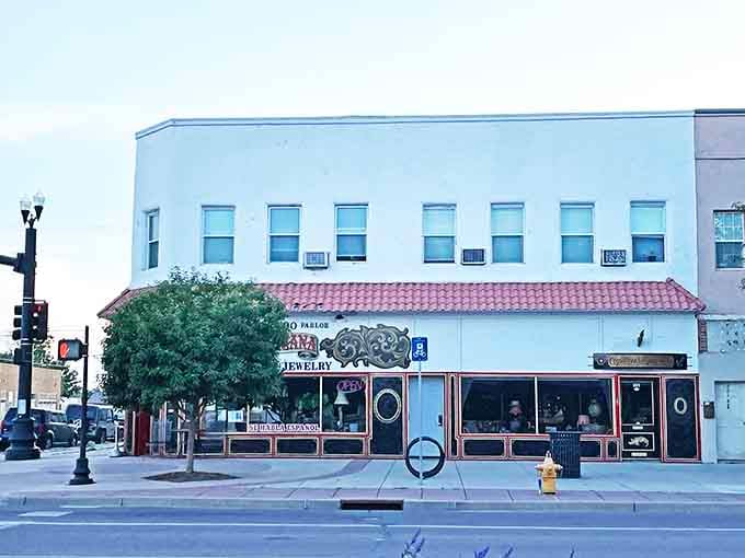 Fort Morgan's downtown trees provide welcome shade along streets where practical storefronts serve the community's everyday needs with reliability.