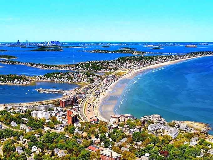 That sweeping beach curves like a giant's smile, connecting neighborhoods across water in one spectacular sandy embrace.