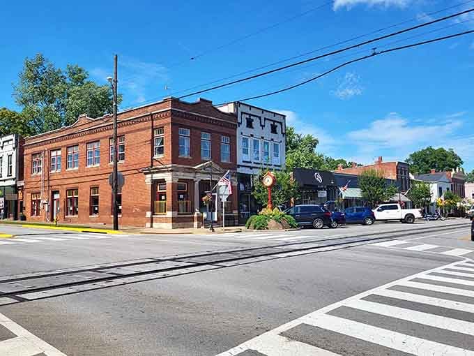 Warm brick buildings in shades of rust and terra cotta create a streetscape that feels welcoming and lived-in.