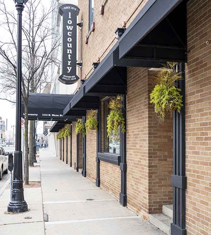 Hanging ferns and urban streetscape blend beautifully, creating an oasis where shrimp and grits reign supreme year-round.