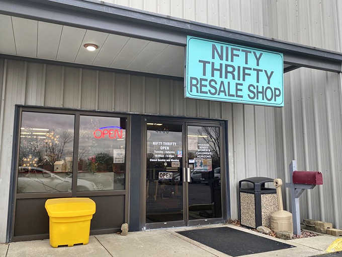 That bright turquoise sign pops against the industrial exterior like a promise of colorful finds waiting just inside.