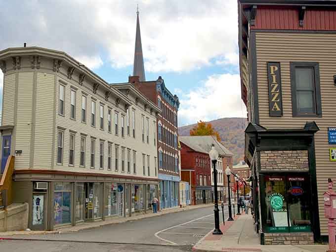 Mountain views frame historic streets where church steeples pierce blue skies and neighbors still wave to strangers.