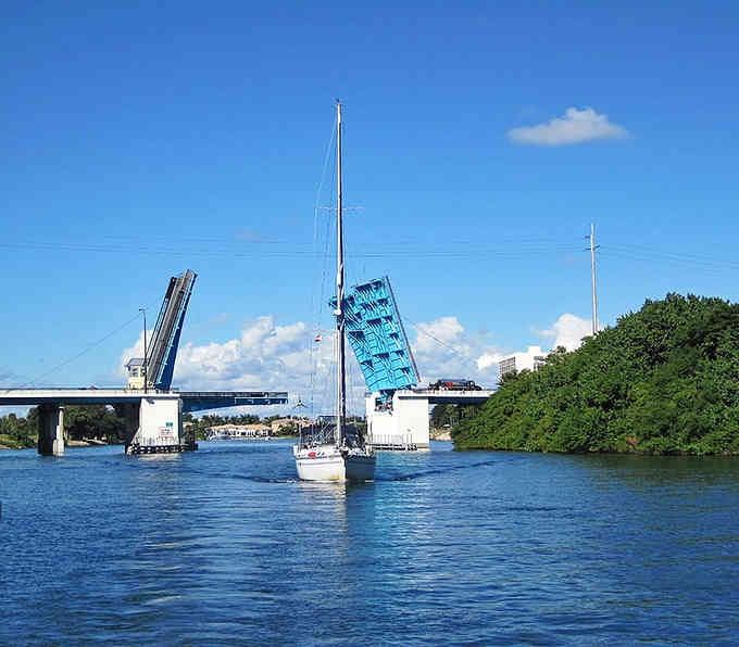That bright blue drawbridge opens for passing sailboats, a daily dance between land and water that never gets old.