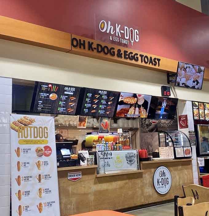 The sleek counter setup showcases colorful menu boards displaying Korean hot dog innovations that'll make your taste buds dance.