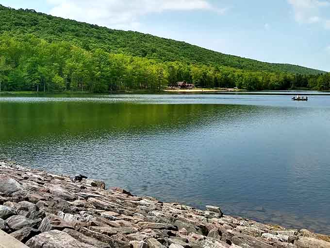 The rocky shoreline and lush green mountains create a rugged beauty that feels wonderfully untouched and timeless.