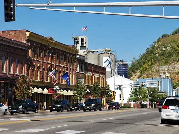 Ornate cornices and arched windows tower over the street like proud guardians of a bygone manufacturing era.