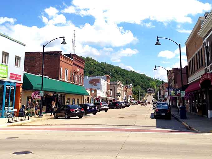 Main street stretches invitingly under blue skies, promising local shops and friendly faces at every welcoming storefront.