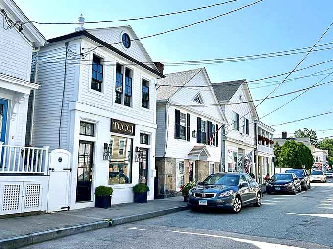 Stroll past these beautiful historic white buildings in a charming coastal village, where quaint shops and clear skies create perfection.