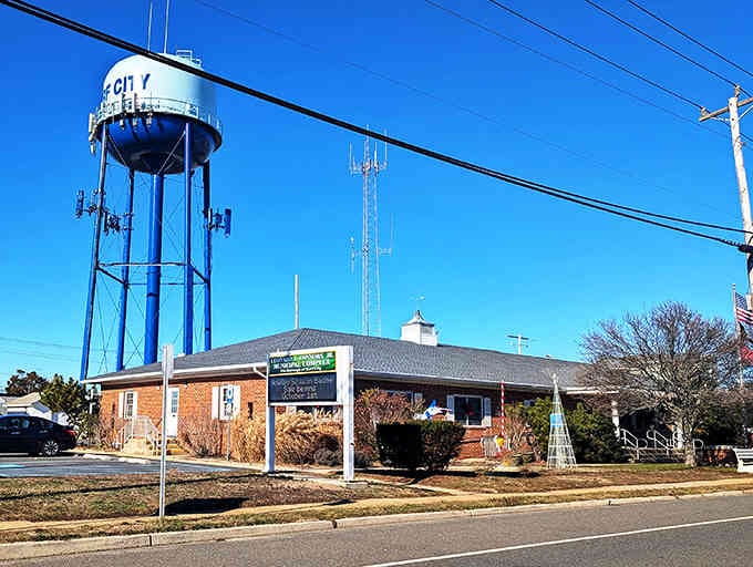 That bright blue water tower stands tall like a cheerful beacon, announcing you've arrived somewhere special and welcoming.