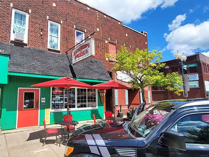 Cheerful turquoise and red storefronts pop against brick neighbors, proving small-town businesses still know how to stand out with style.