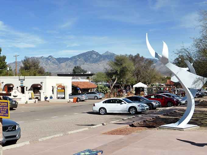 That striking white sculpture reaches skyward like modern art meeting desert landscape in perfect harmony and conversation.