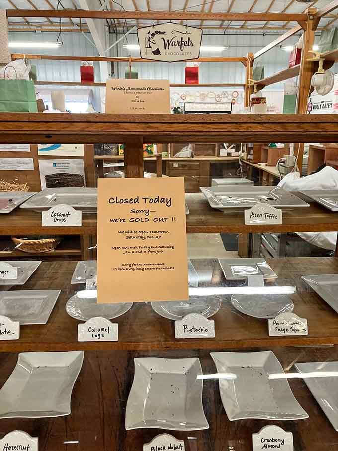 Rustic wooden shelves displaying handmade chocolates – though that "sold out" sign means you're not alone here.