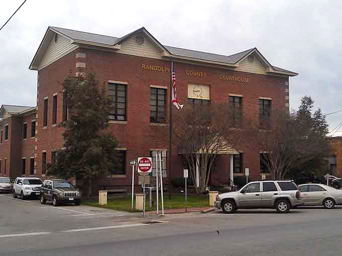 The stately courthouse anchors this town square, its solid brick presence commanding respect like a beloved grandfather.