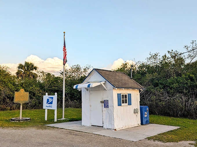 That white building with blue shutters and the American flag proves you don't need square footage to deliver mail.