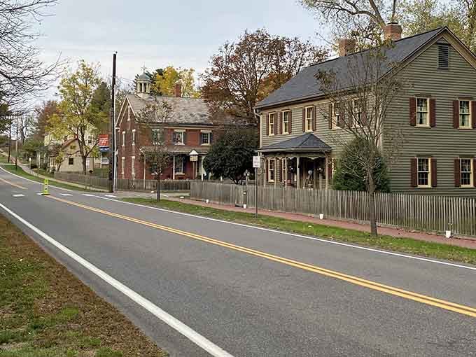 Autumn leaves accent these carefully preserved structures along a quiet road where time moves at a gentler pace.