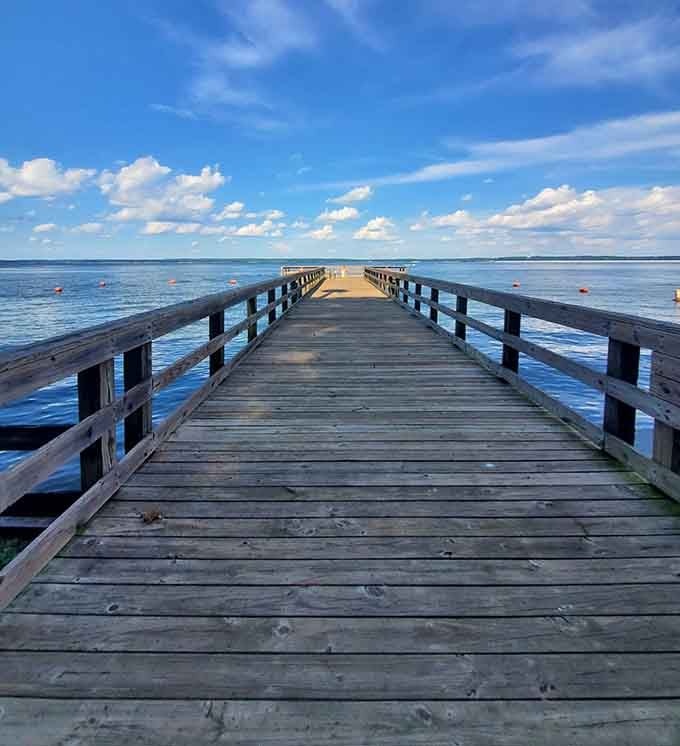 The fishing pier stretches toward endless blue water, offering the kind of peace that makes your blood pressure drop instantly.