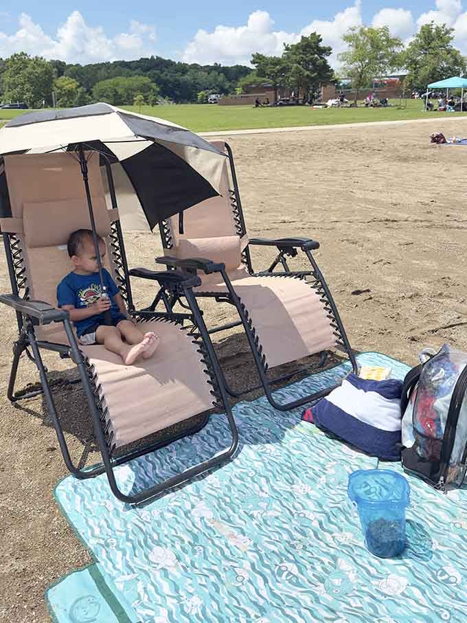 Smart setup right there, providing shade for the littlest beachgoers who haven't quite mastered the art of sunscreen application.