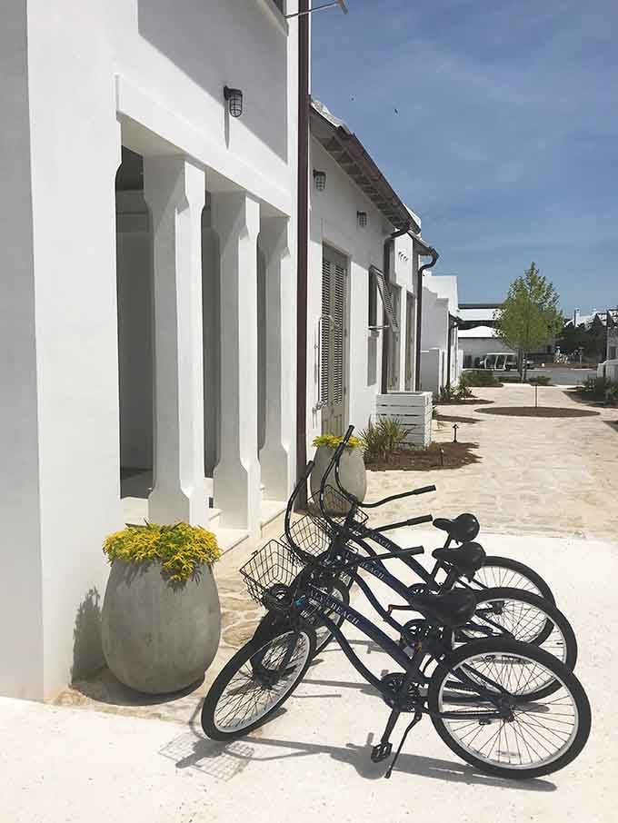 Bikes waiting patiently by white walls, ready to take you exploring without the hassle of finding parking spots.