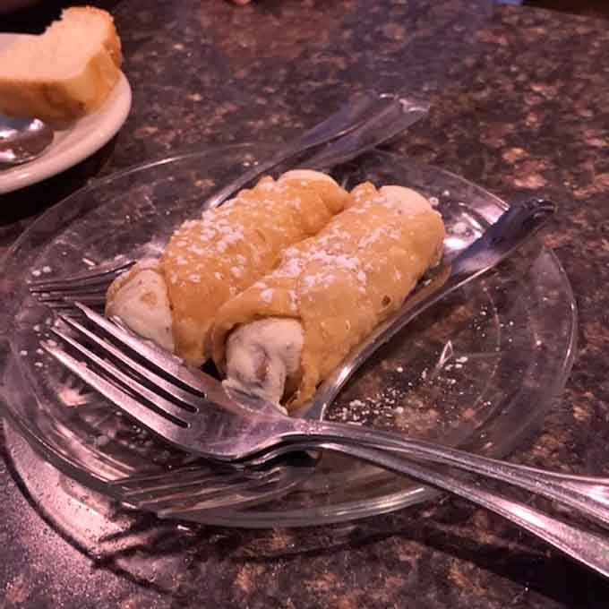 Two crispy cannoli shells stuffed with sweet ricotta filling that'll transport you straight to Little Italy.