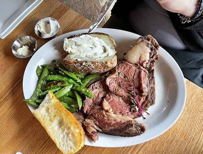 Prime rib sliced thick with a loaded baked potato reminds you that not everyone comes for the fish.