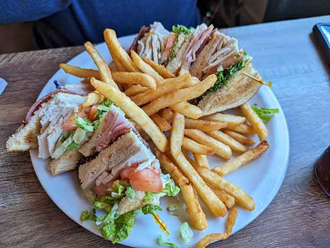 That club sandwich towers higher than your average coastal lighthouse. Structural engineering meets lunch perfection here.