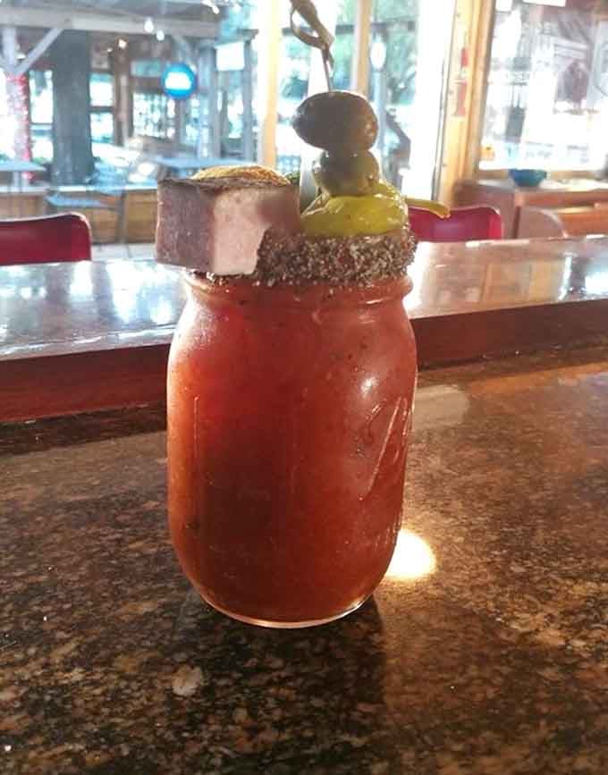 This Bloody Mary comes garnished with enough bacon to qualify as both beverage and appetizer in one glorious glass.