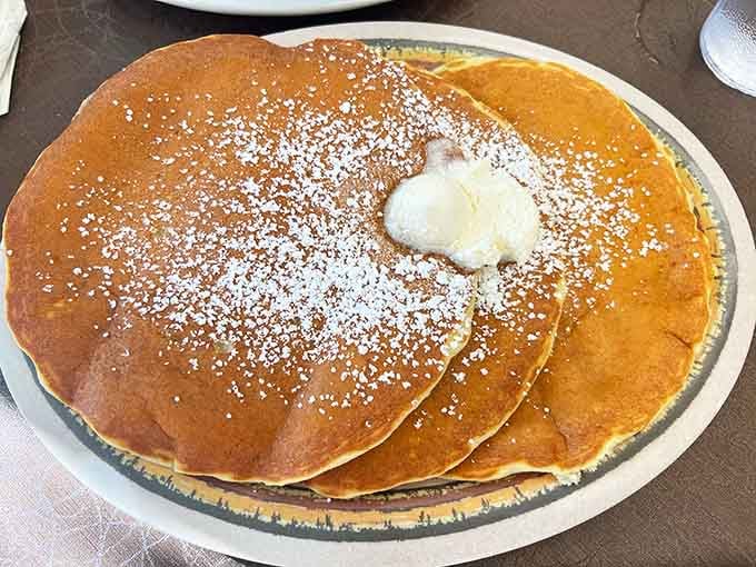 These golden pancakes dusted with powdered sugar are exactly why the sign outside advertises them so proudly.