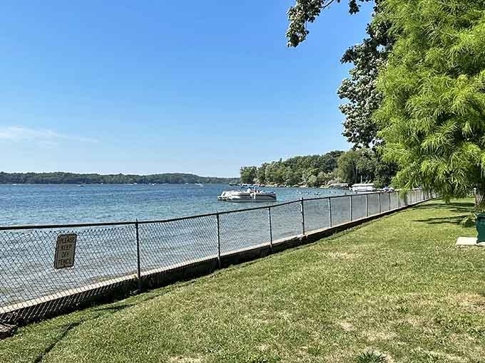 Manicured lawns stretch toward the shoreline, offering prime real estate for frisbee tournaments and lazy afternoon naps.