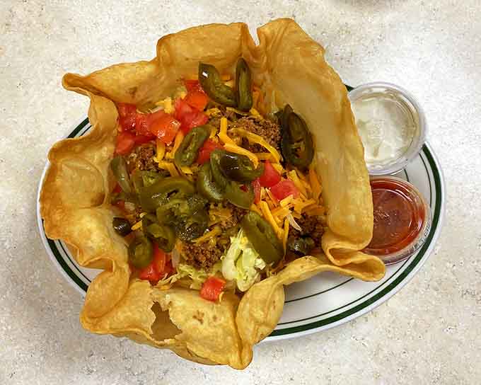 Taco salad served in an edible bowl, proving that sometimes the best utensil is the plate itself, genius.