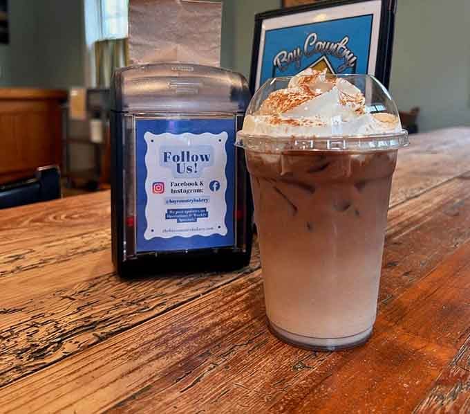 Iced coffee topped with enough whipped cream to make your cardiologist schedule an intervention, worth every sip.